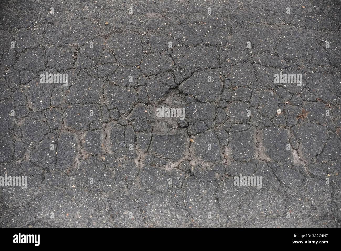 Lombardy, Italy March 1st 2025 Weathered asphalt surface revealing ...