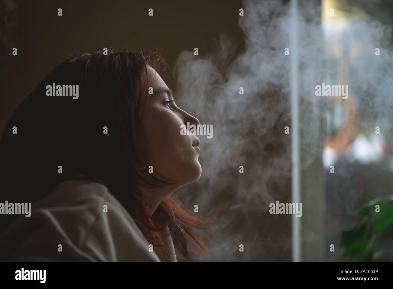 cute teen girl enjoys the benefits of a humidifier, breathing clean and ...