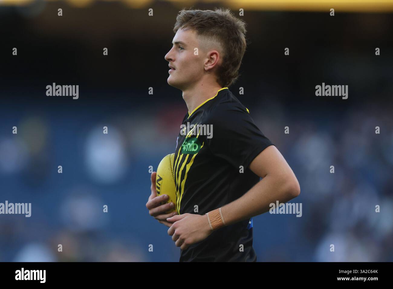 Melbourne, Australia. 13th Mar, 2025. Luke Trainor of the Tigers warms ...