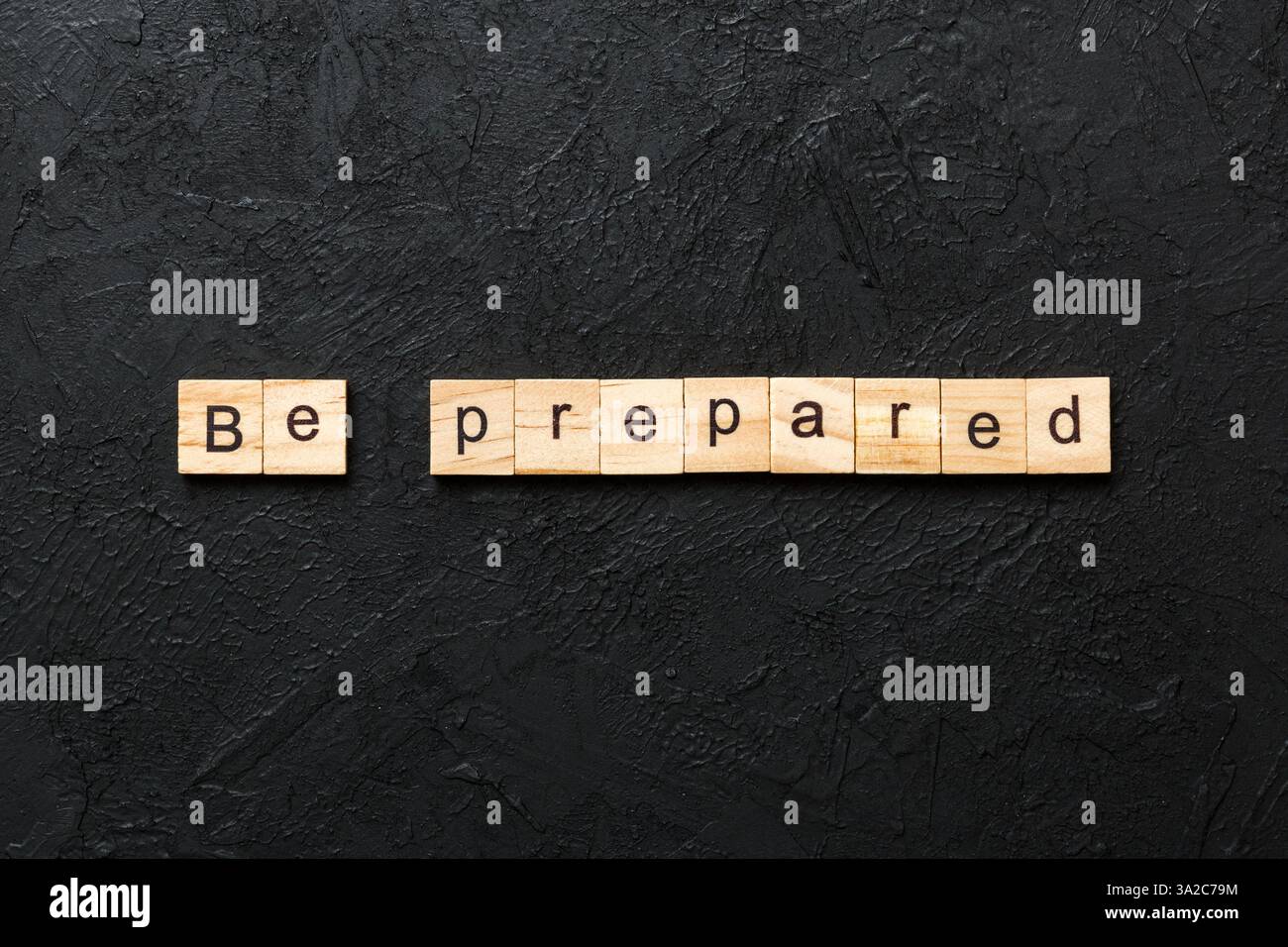 BE PREPARED word written on wood block. BE PREPARED text on cement ...