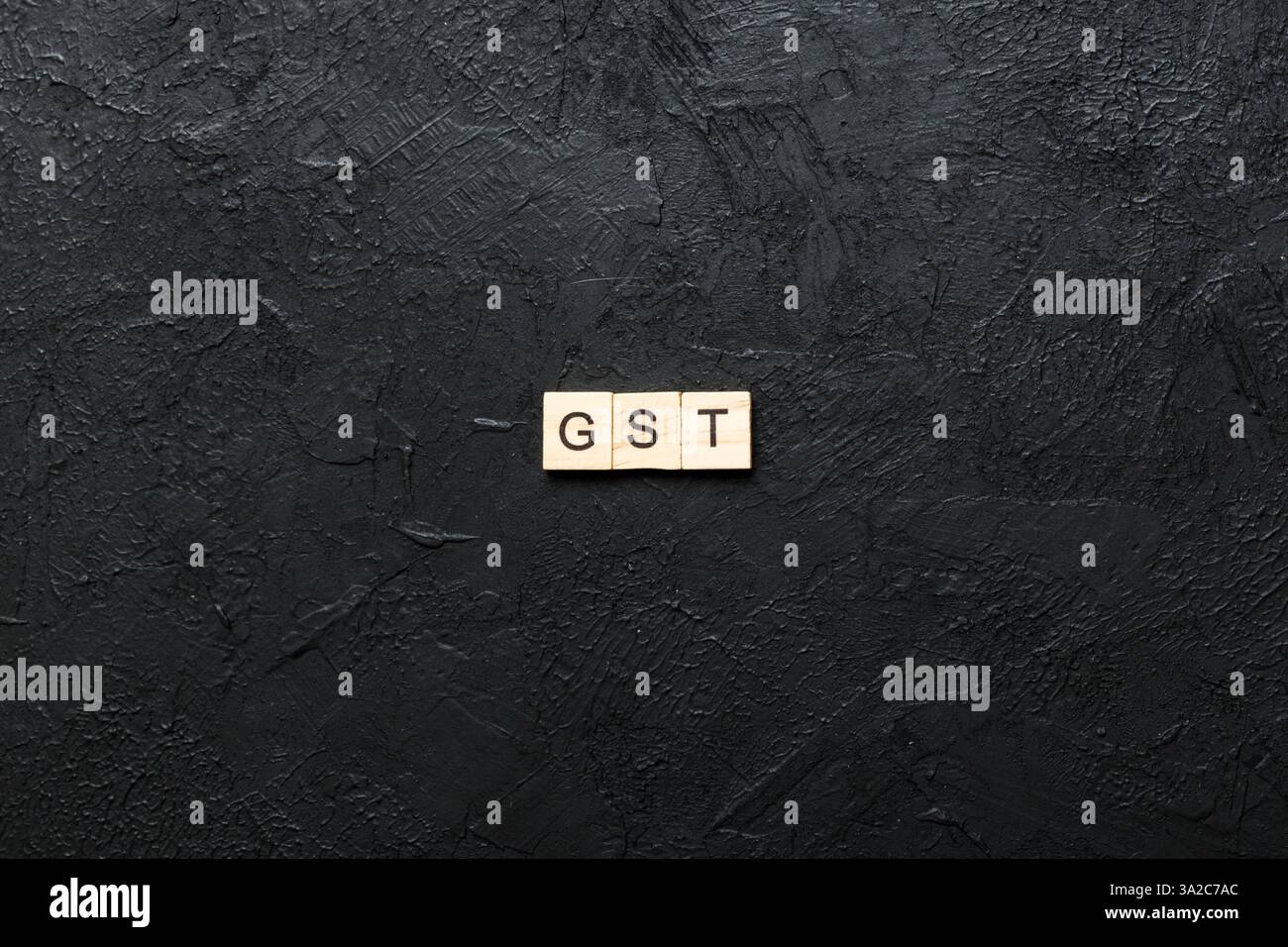 GST word written on wood block. Good Services Tax text on cement table for your desing, concept ...