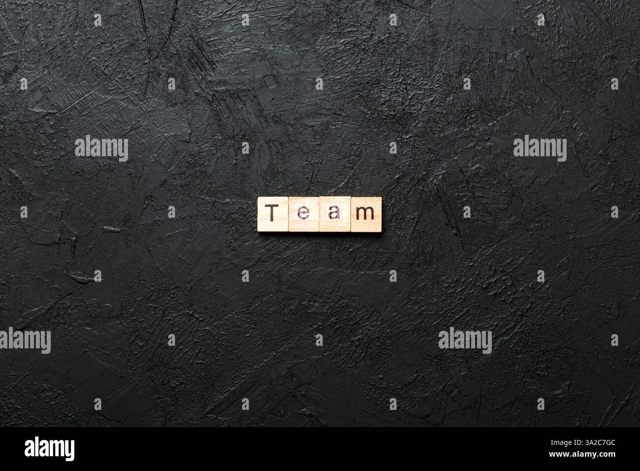 team word written on wood block. team text on cement table for your ...