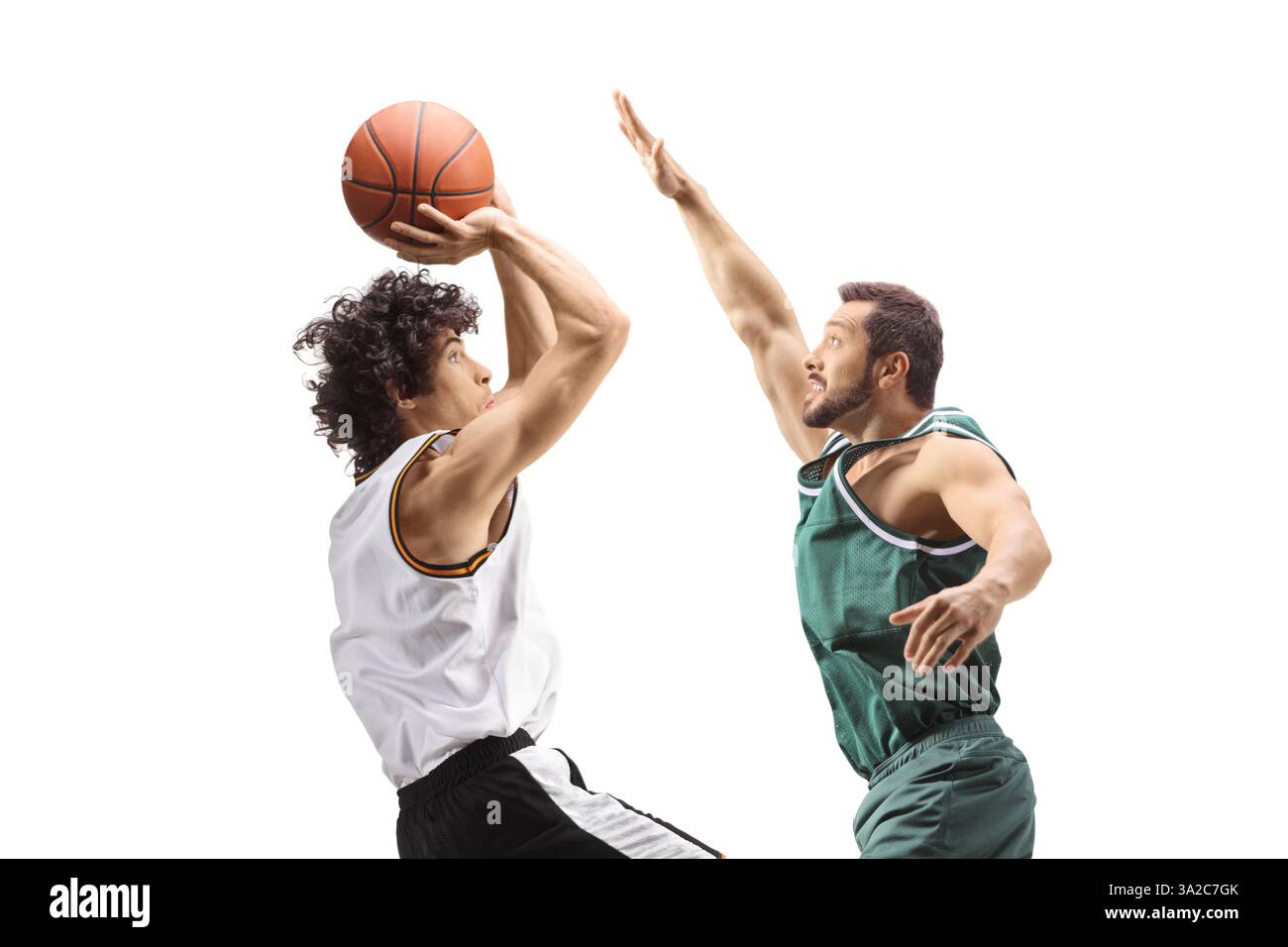 Basketball player jumping and performing block to another player ...