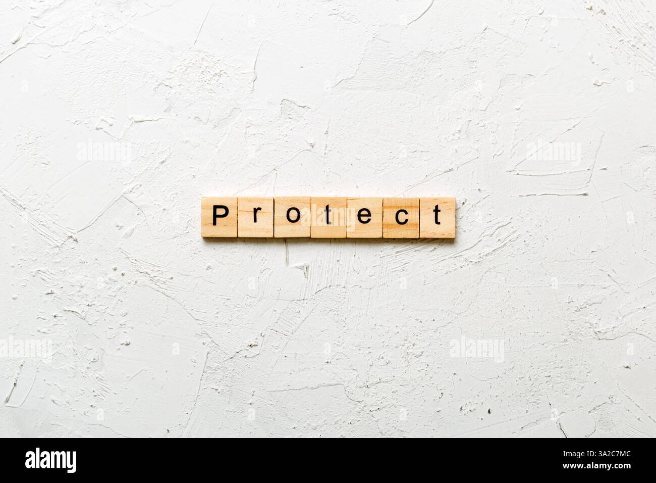 PROTECT word written on wood block. PROTECT text on cement table for ...