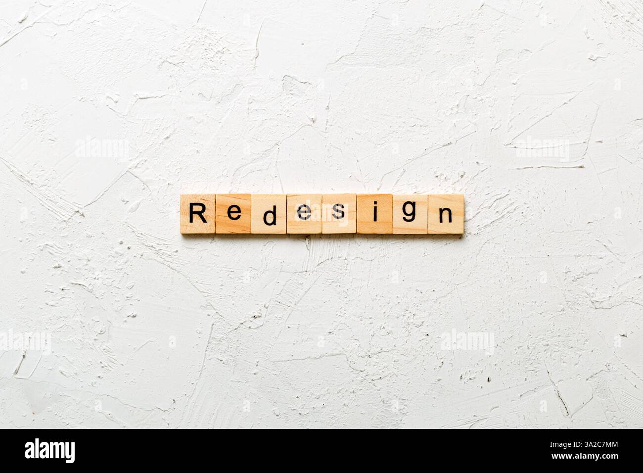 REDESIGN word made with wooden blocks concept Stock Photo - Alamy