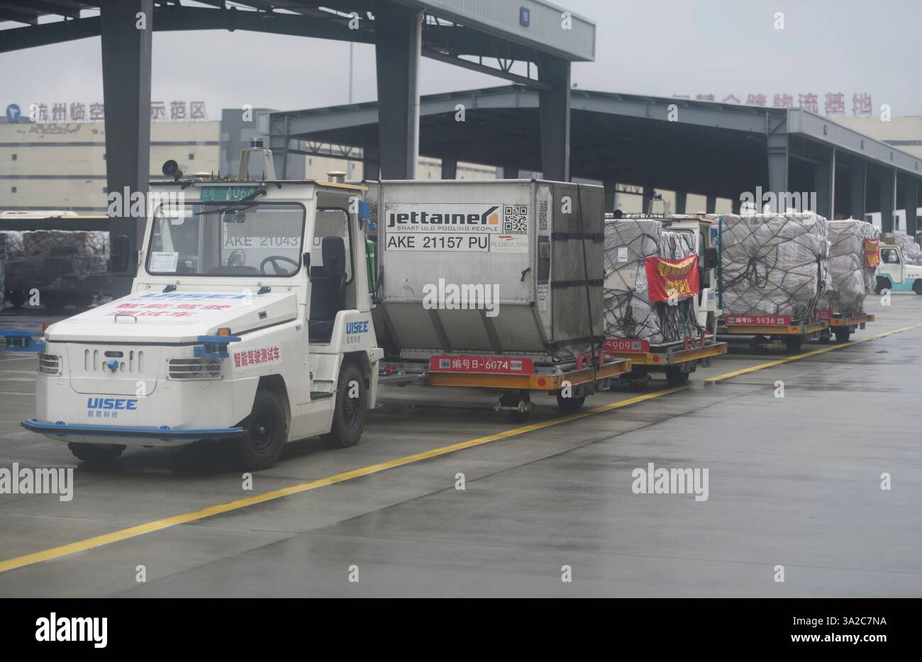 A driverless cargo tow tractor works at Hangzhou Xiaoshan International ...
