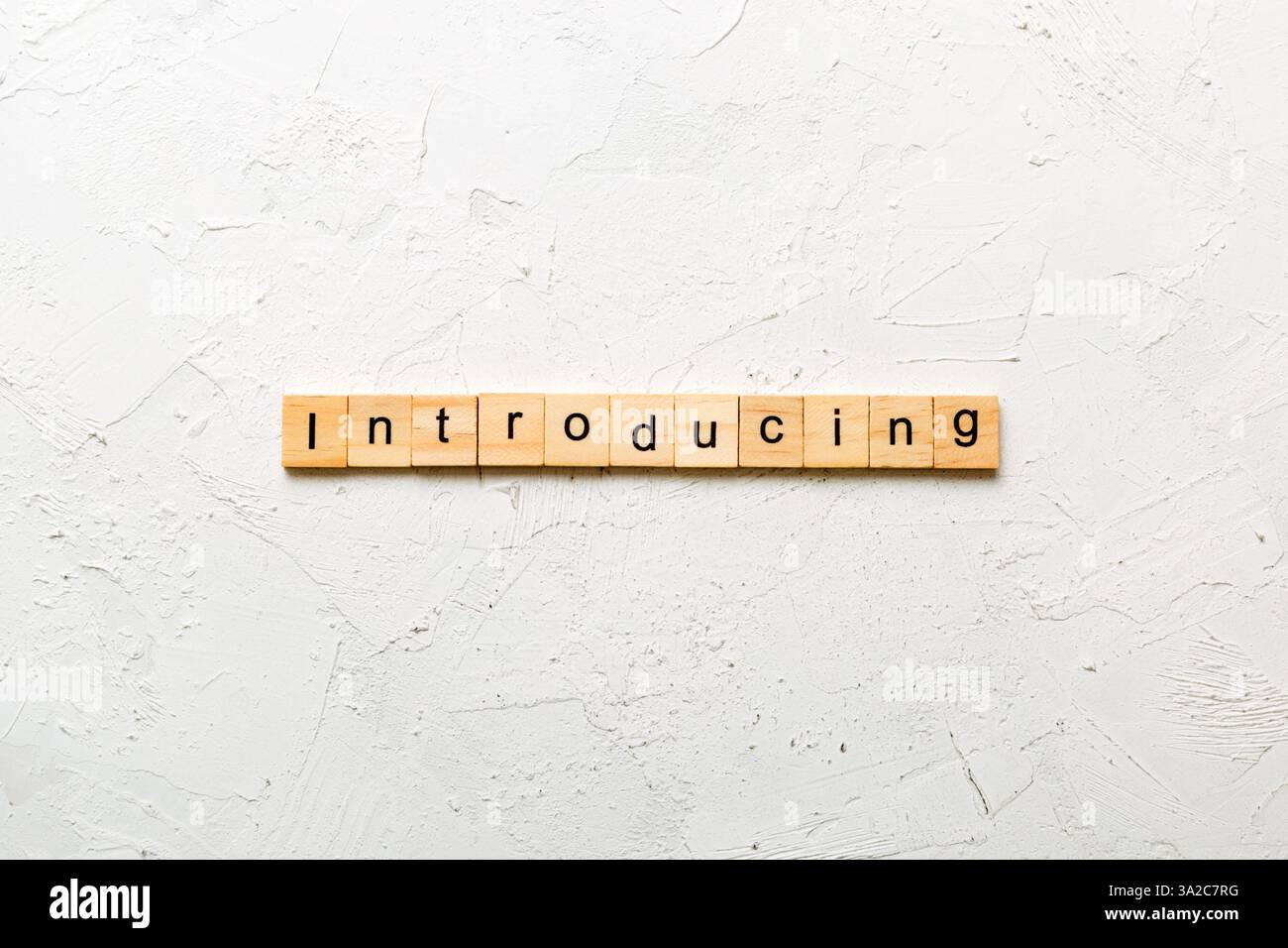 introducing word written on wood block. introducing text on table ...