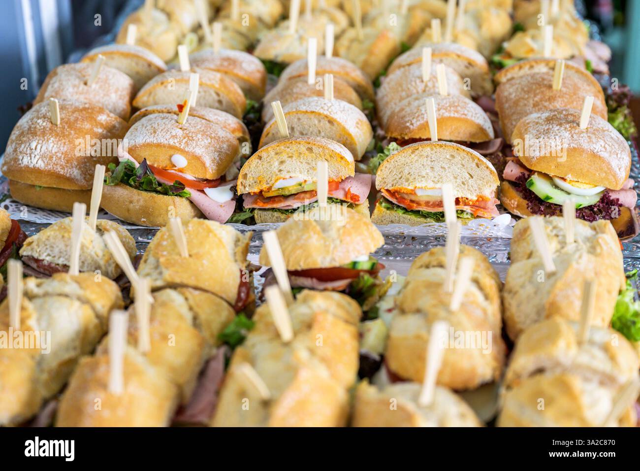 many spike Club sandwich arrangement buffet on a rustic table witch ...