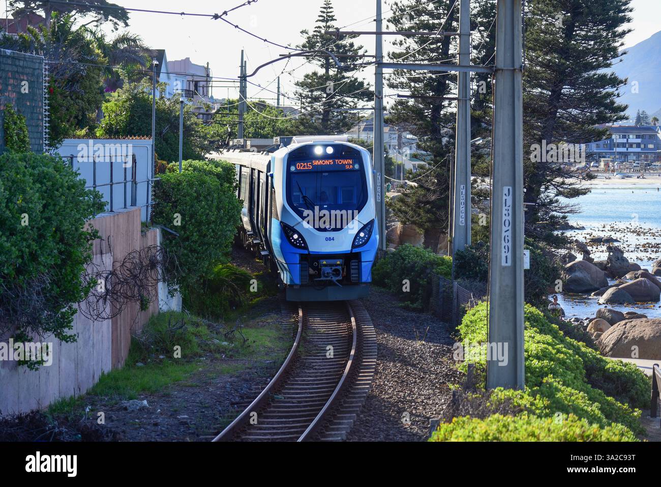 Coastal passenger train passing on the way to Simons Town, Cape Town ...