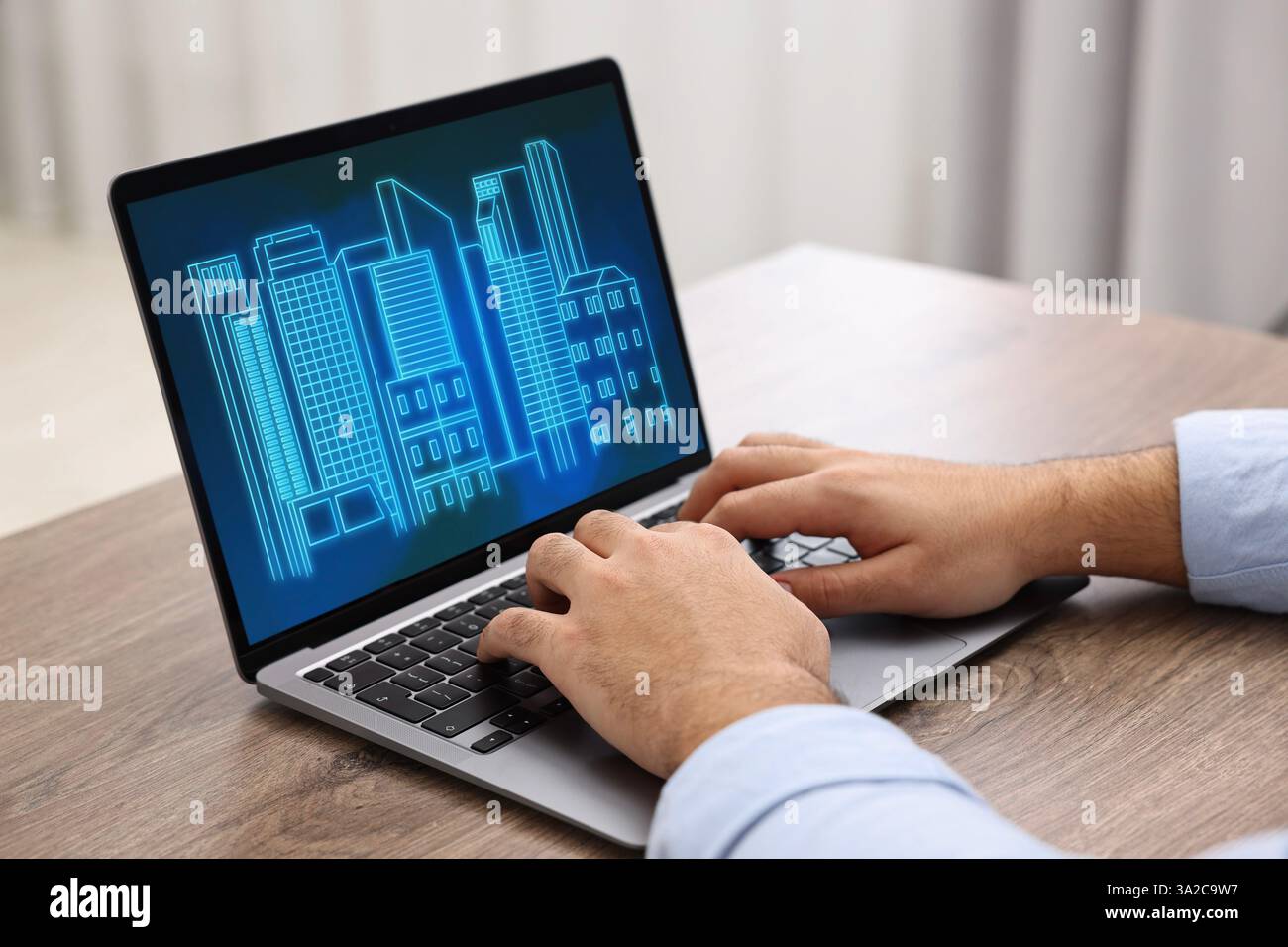 Building information modeling. Man working at laptop indoors, closeup ...
