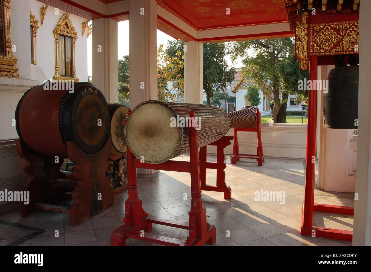 Large, elaborately carved wooden gong pendulum at a Thai temple, used ...
