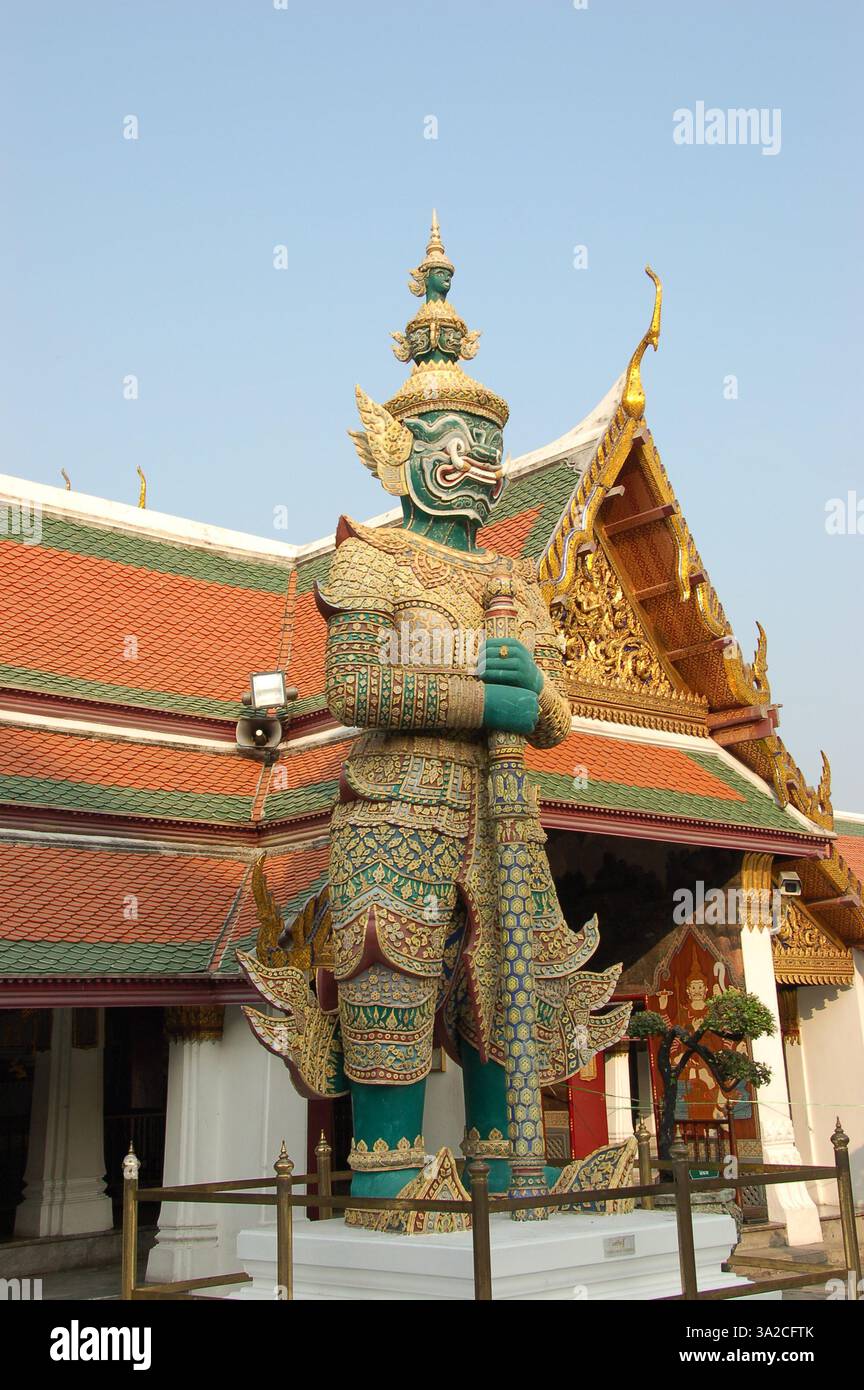 Colorful green and gold giant guardian statue at a Thai temple in ...
