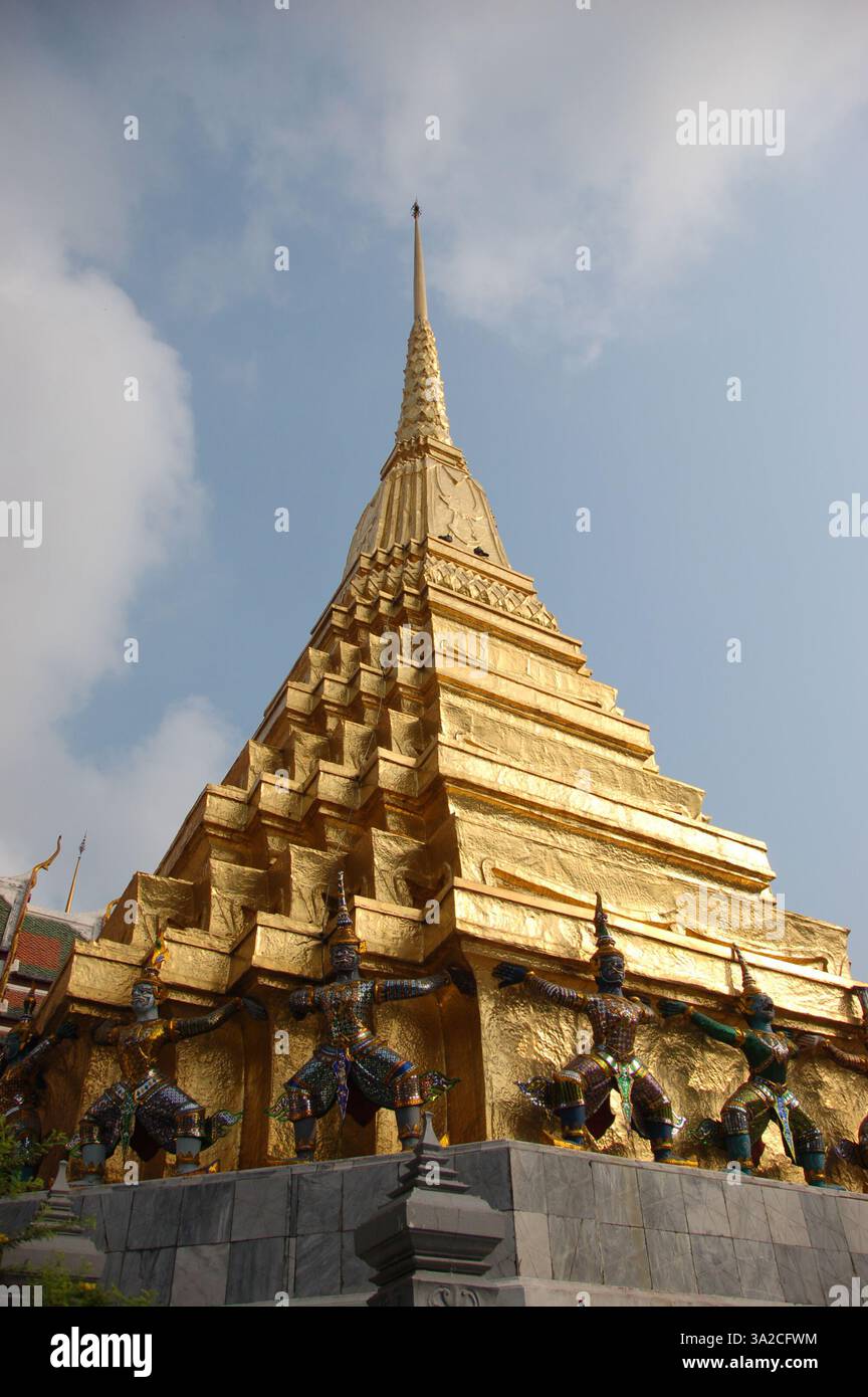 Golden chedi at Bangkok’s Grand Palace, supported by colorful Yaksha ...