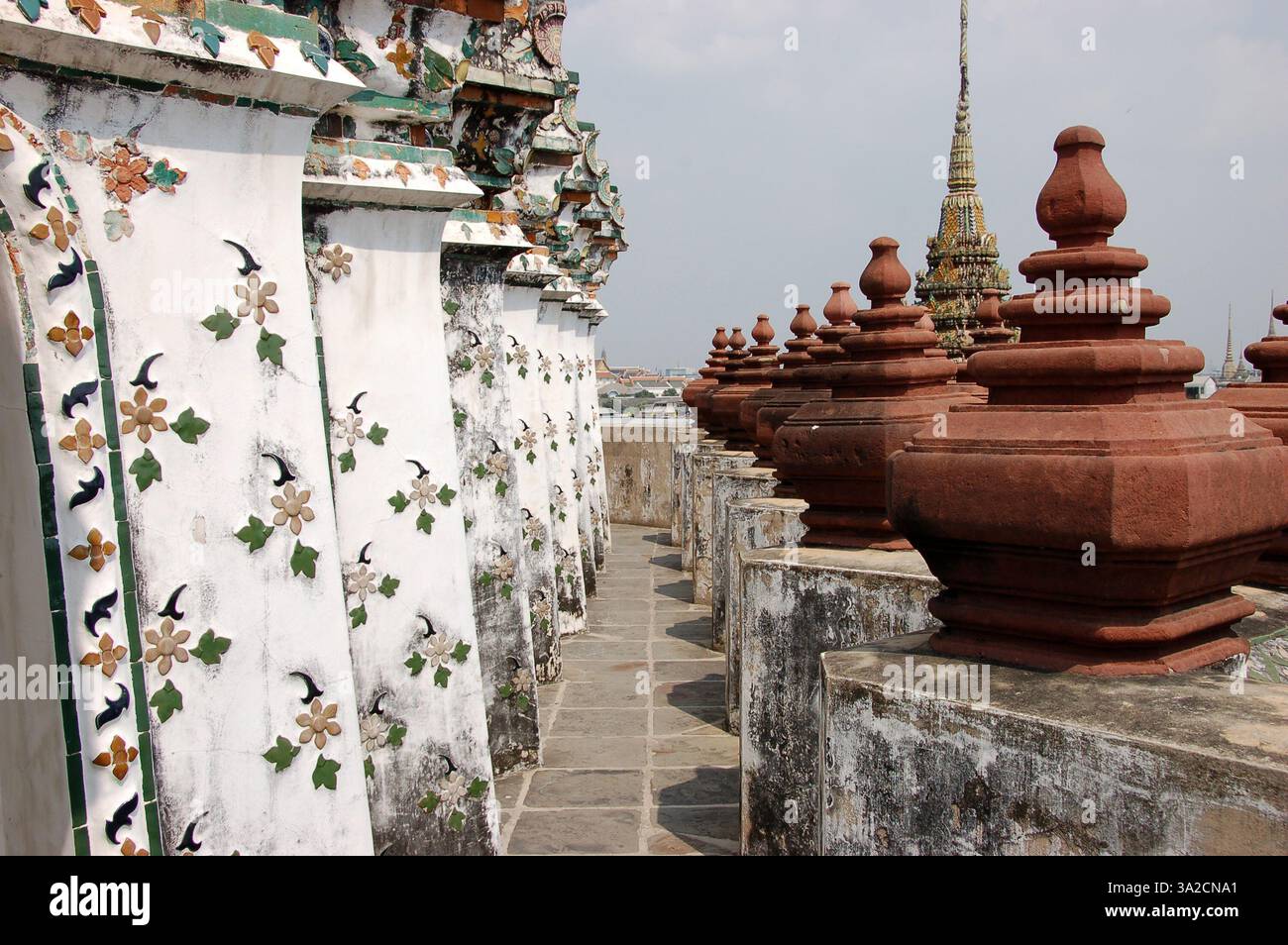 Decorative ceramic floral patterns and red stupas adorn the terrace of ...