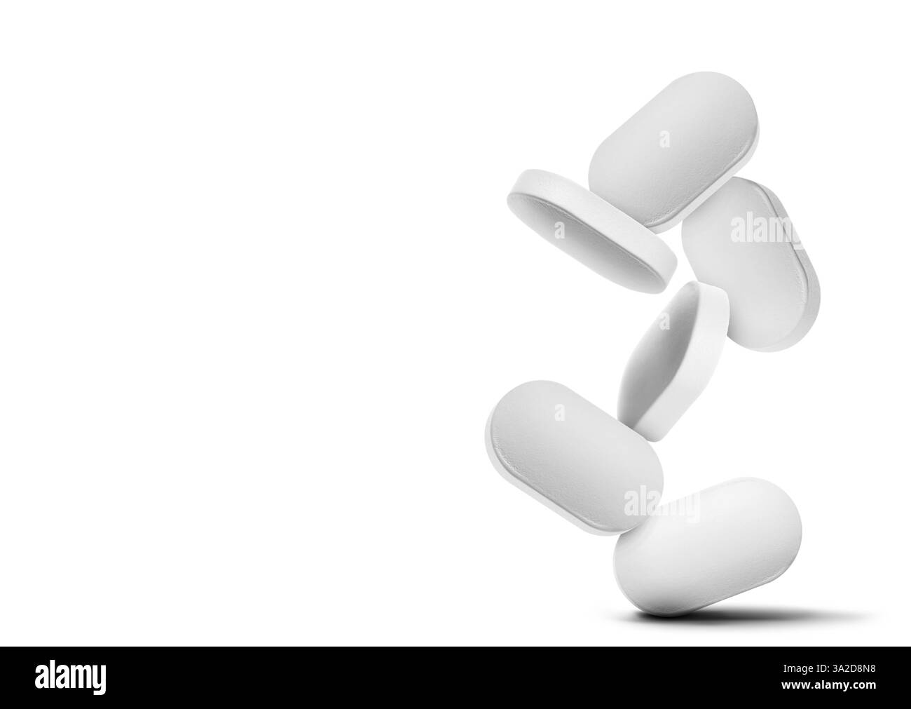 Many medical pills falling on white background Stock Photo - Alamy