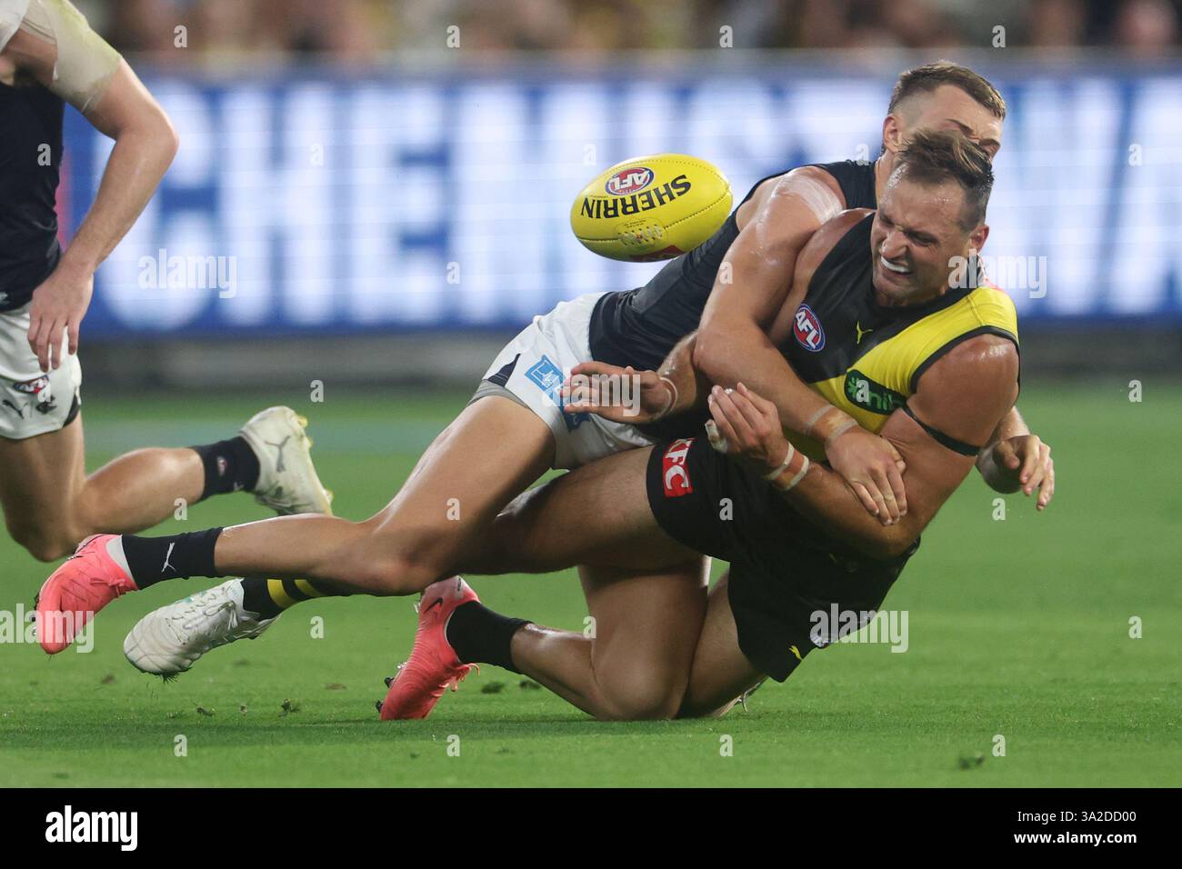 Melbourne, Australia. 13th Mar, 2025. Toby Nankervis of the Tigers is tackled by Patrick Cripps ...