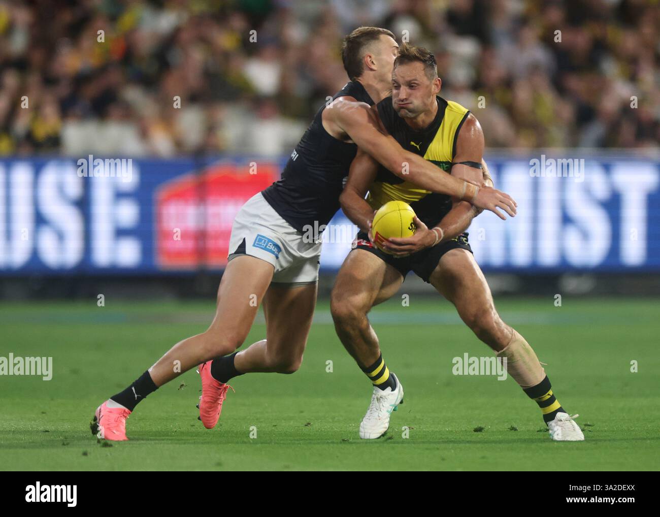 Melbourne, Australia. 13th Mar, 2025. Toby Nankervis of the Tigers is tackled by Patrick Cripps ...
