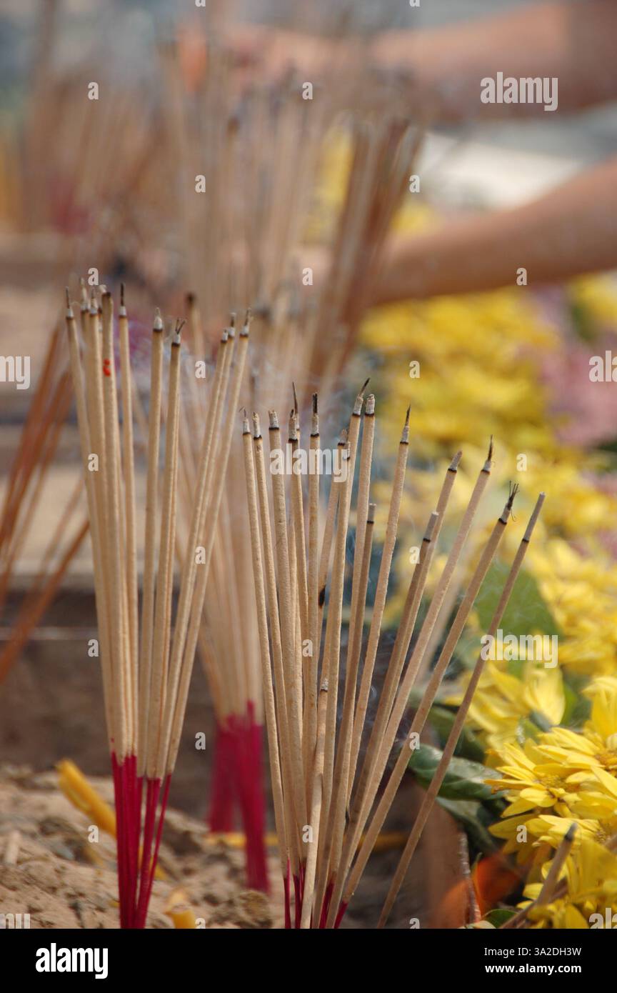 Bundle of burning incense sticks, commonly offered at temples and ...