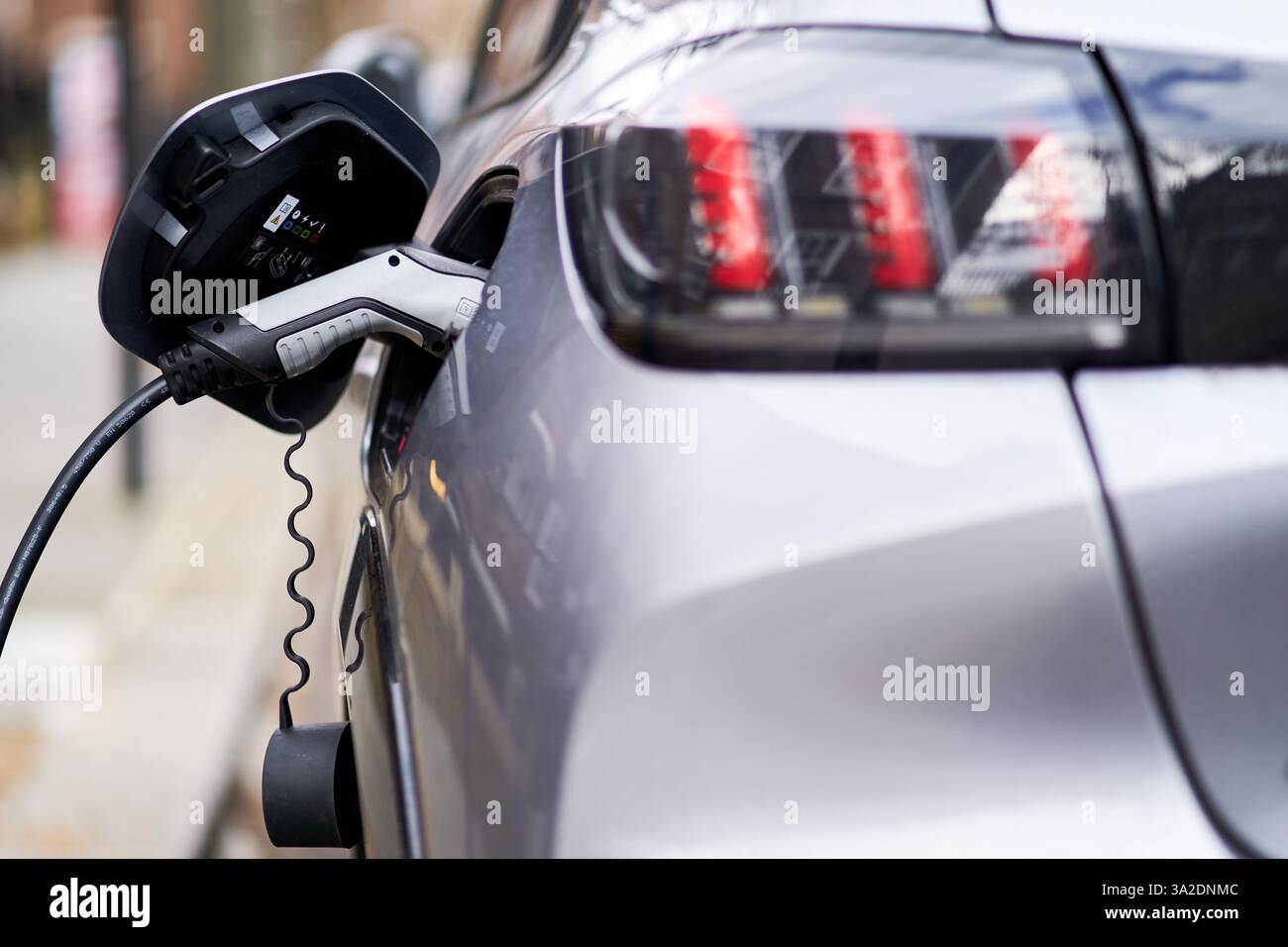 File photo dated 05/03/21 of an electric car plugged into a EV charging ...