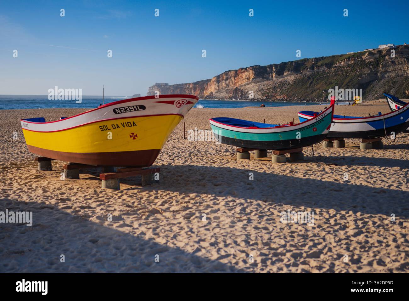 Traditional historical fishing boats on Nazare Beach, Portugal Stock ...