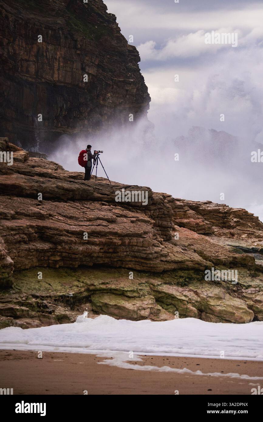 Photographer on cliffs in Praia do Norte (North Beach), listed on the ...
