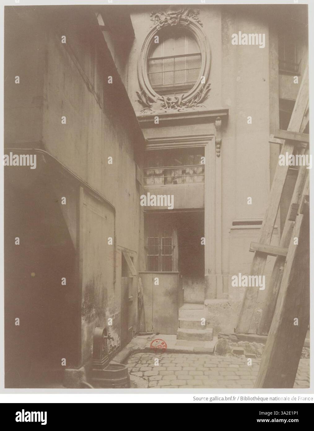 A detailed photograph by Eugène Atget of the Hôtel Colbert’s courtyard ...