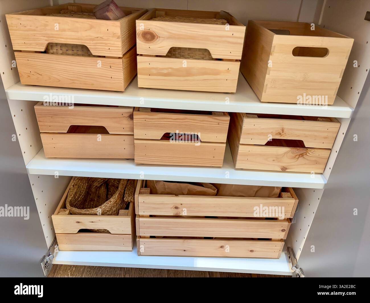 Organized wooden crates inside a kitchen cabinet for efficient storage ...