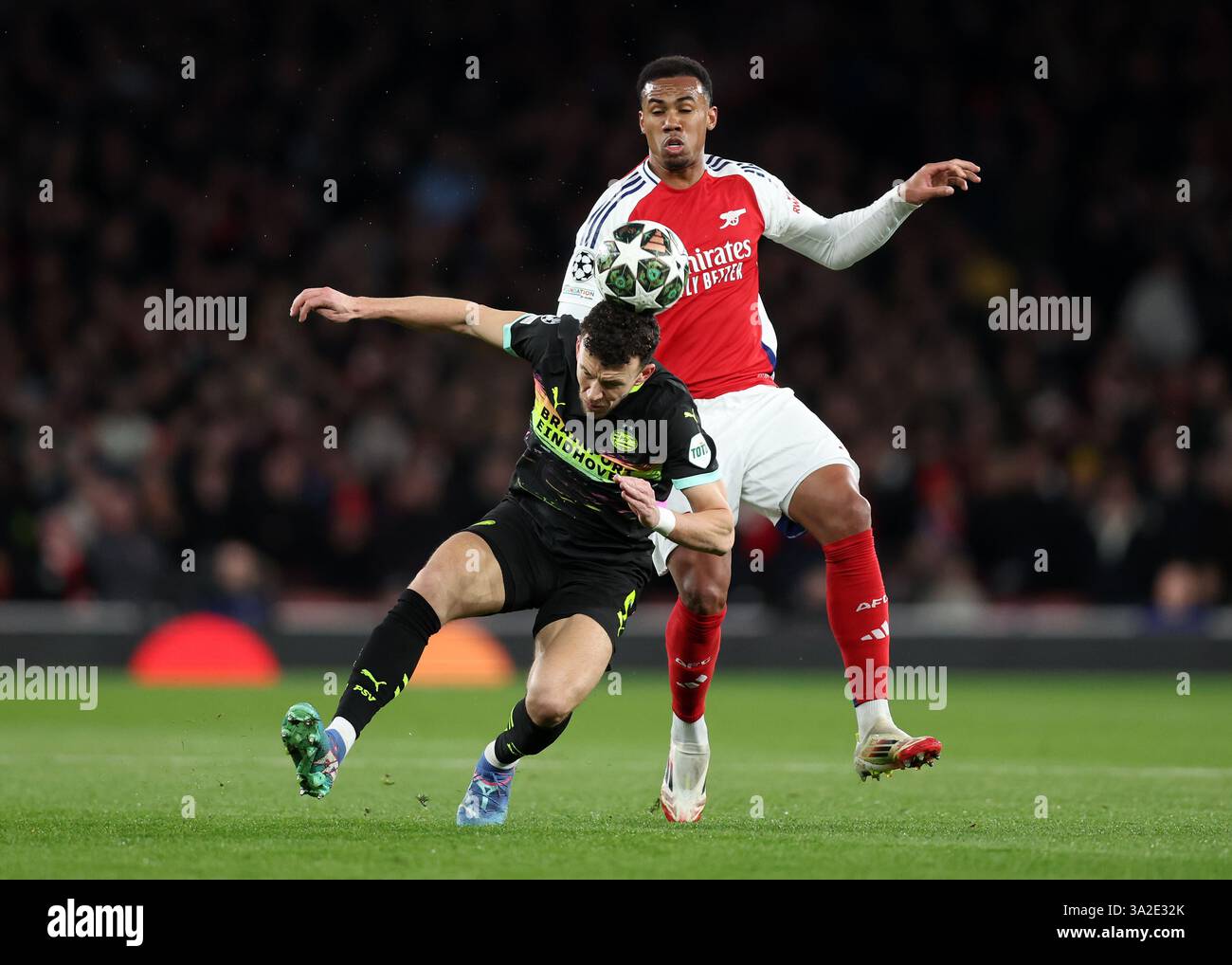 London, England, 12th March 2025. Arsenal's Gabriel with PSV’s Ivan Perisic during the UEFA ...