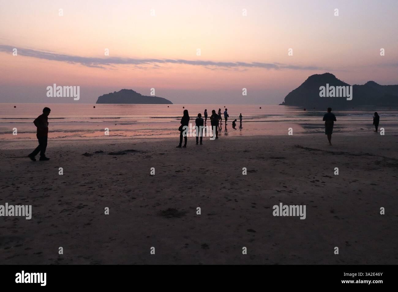 Backlit island with people and sunset light sky background Stock Photo ...