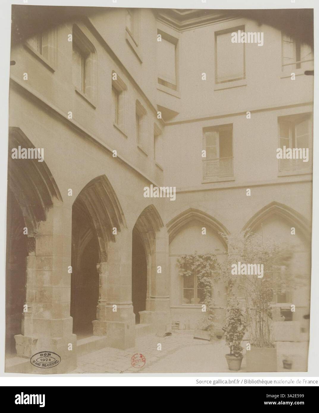 This photograph by Eugène Atget shows the Cloître des Billettes ...