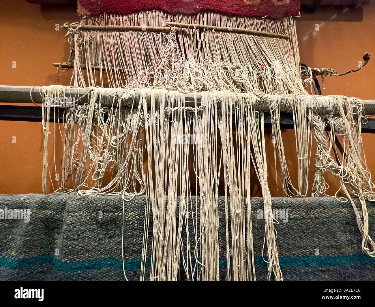Warp threads on a traditional backstrap loom for weaving in the ...