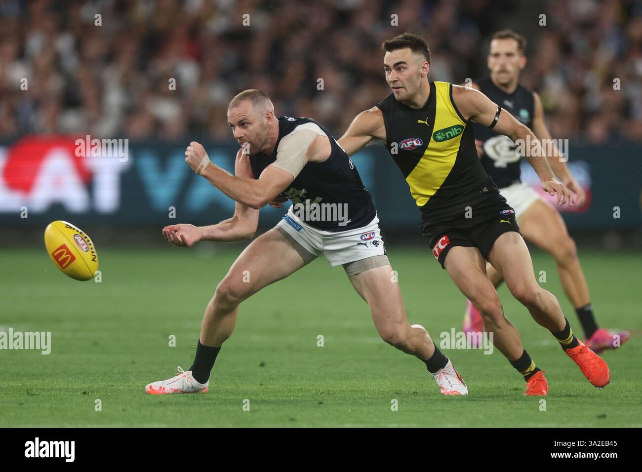 Sam Docherty of the Blues handballs during the AFL Round 1 match ...