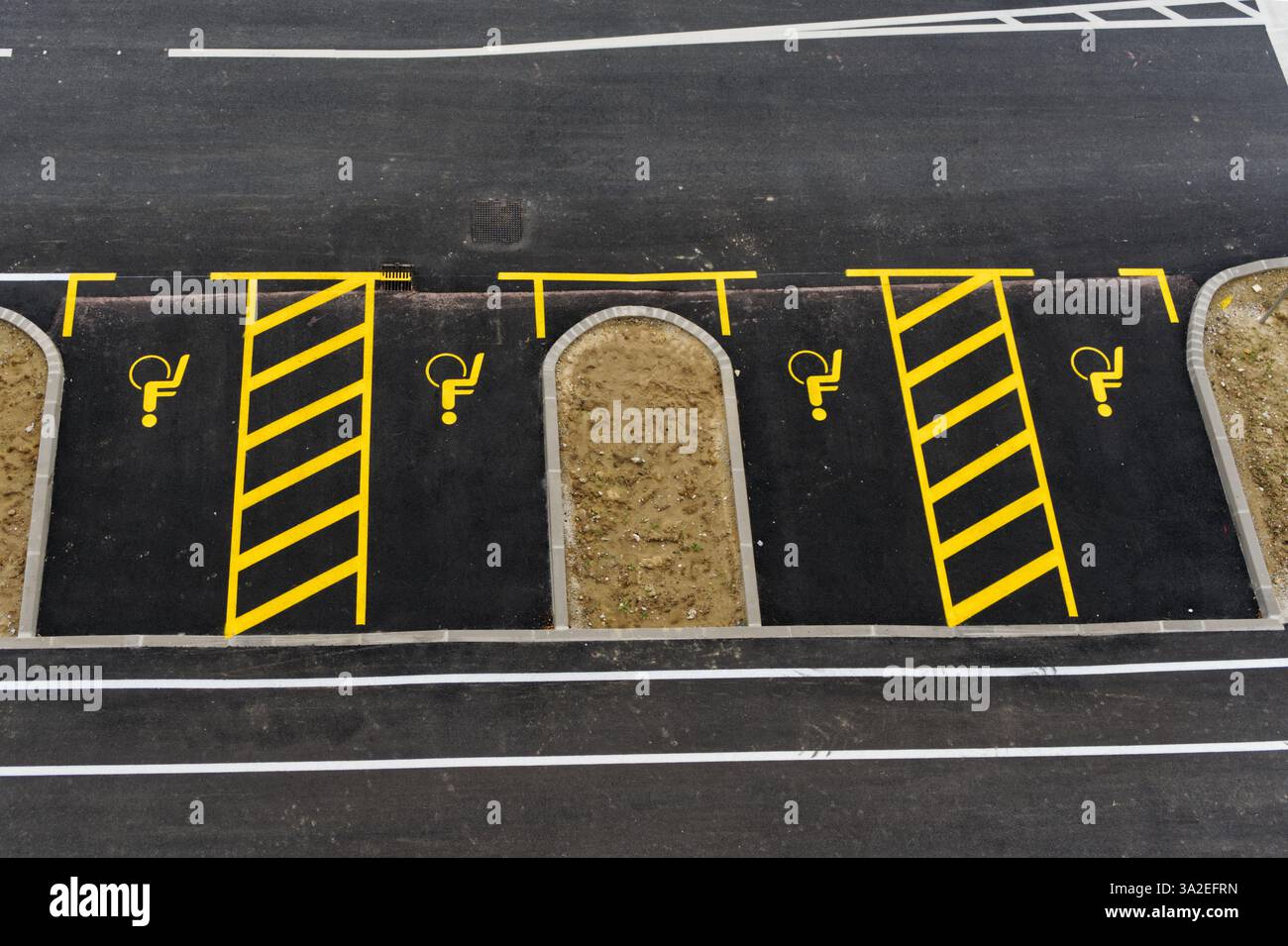 The image shows a section of a parking lot with designated spaces for ...