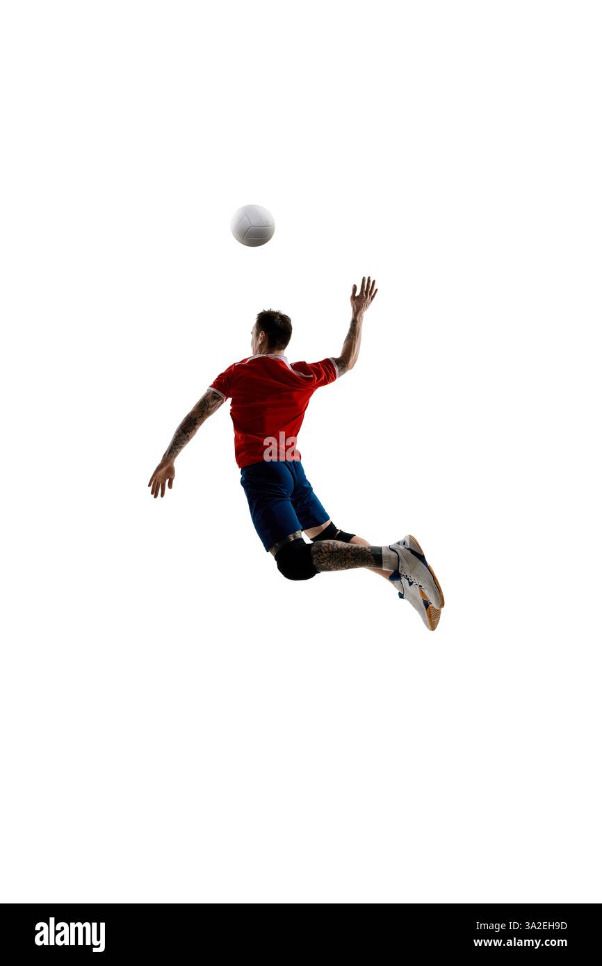 Full-length dynamic image of male volleyball player in motion, jumping ...