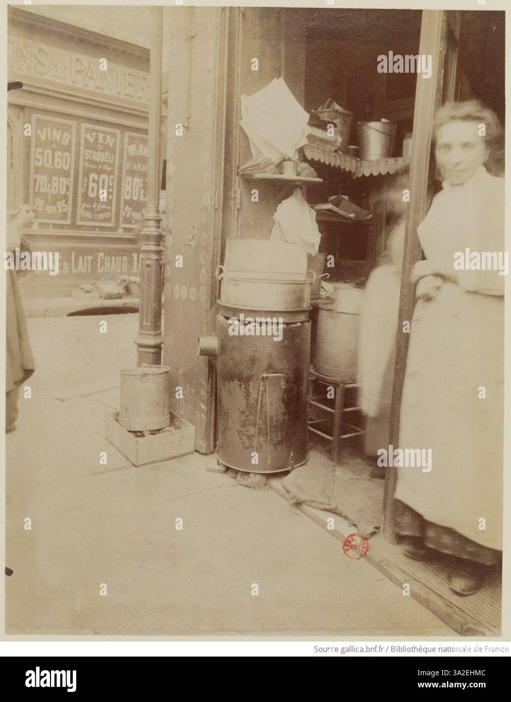 This photograph by Eugène Atget captures a street vendor selling French ...
