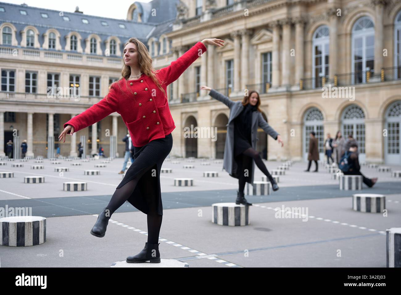 Two stylish women strike elegant ballet-inspired poses on black-and ...