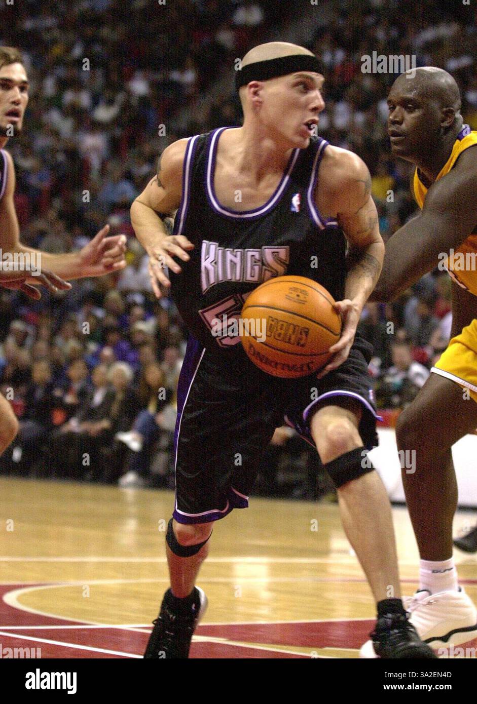 Jason Williams drives the lane against Shaq in the first half. Picture ...
