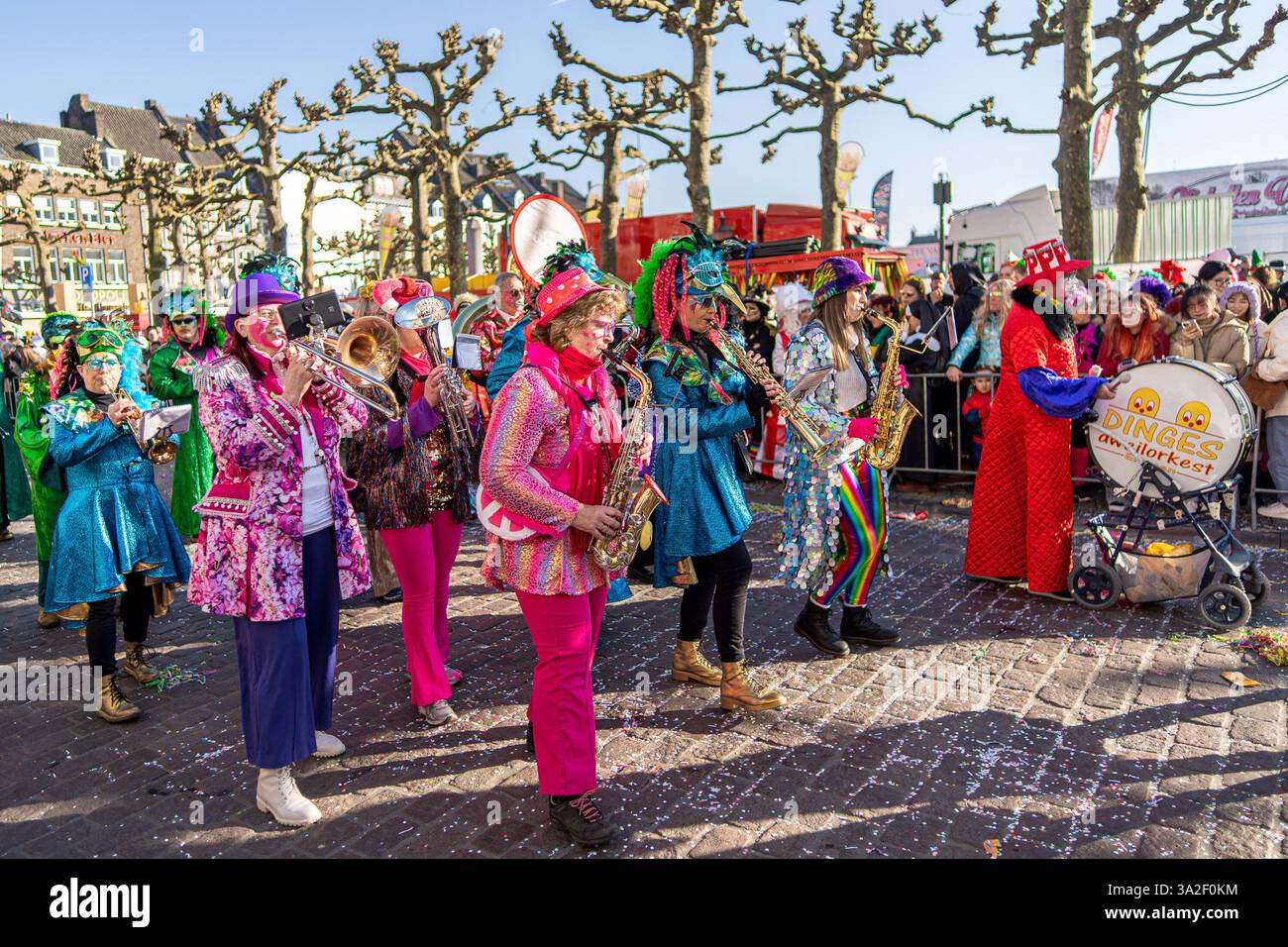 People in masks and costumes parade through the streets of Maastricht ...