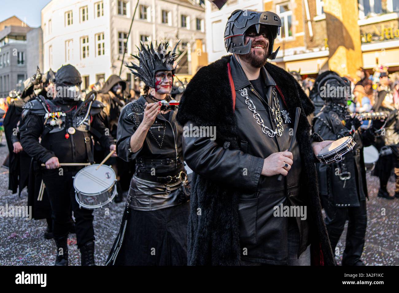 People in masks and costumes parade through the streets of Maastricht ...