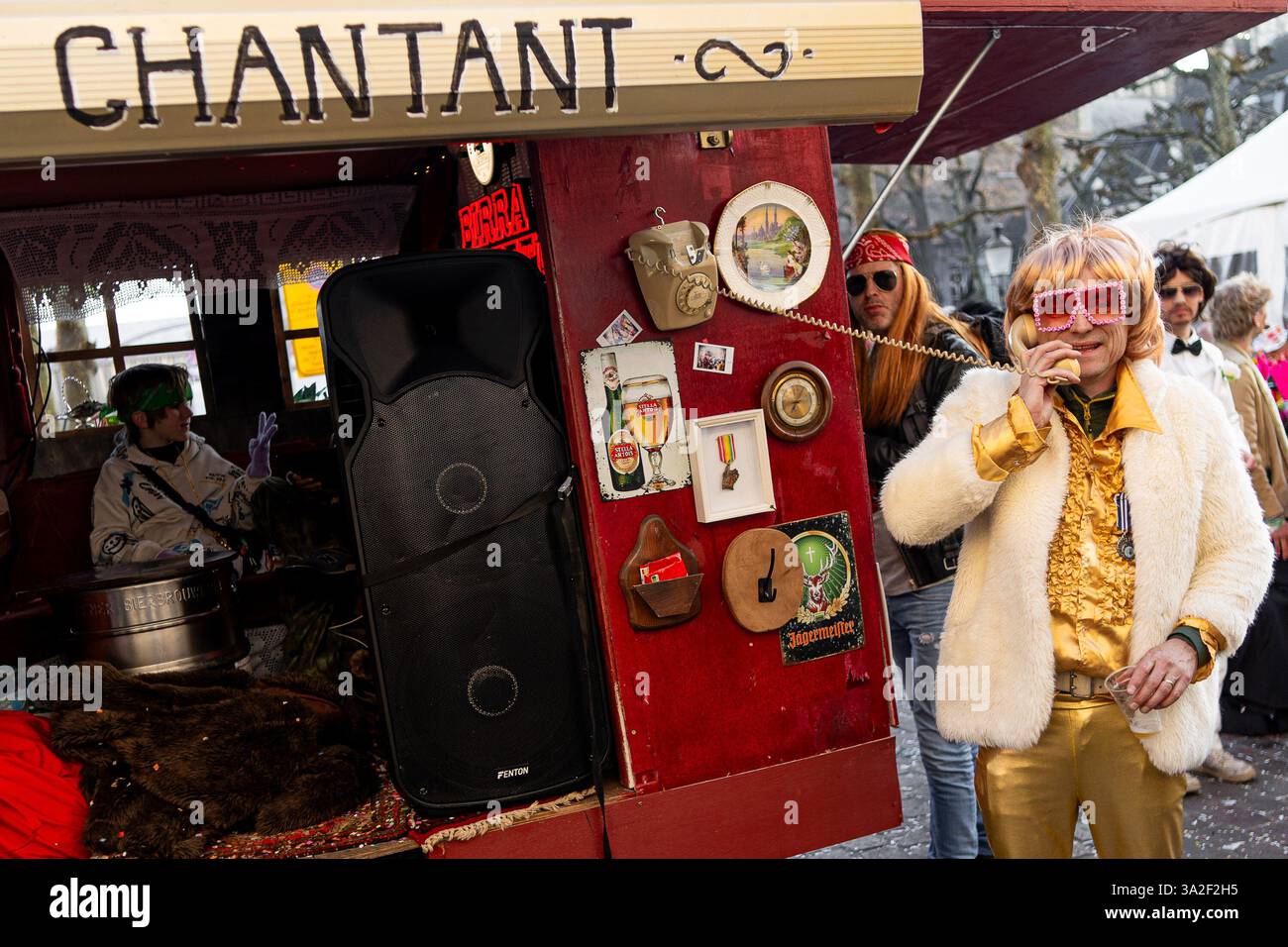 People in masks and costumes parade through the streets of Maastricht ...