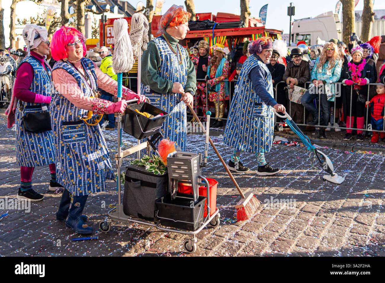 People in masks and costumes parade through the streets of Maastricht ...