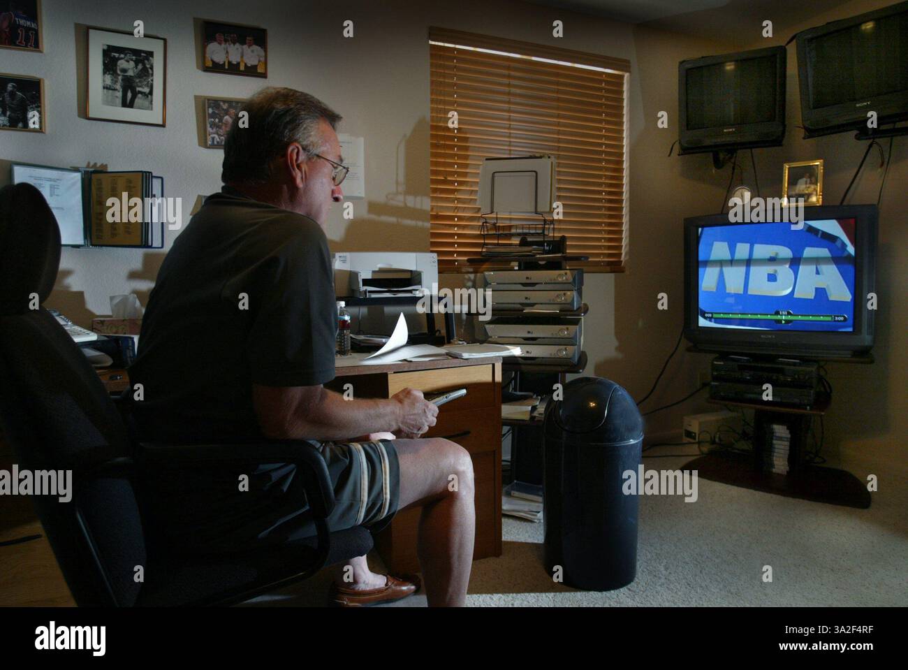 Ed Rush head of the NBA referee's inside his home near Phoenix watches ...