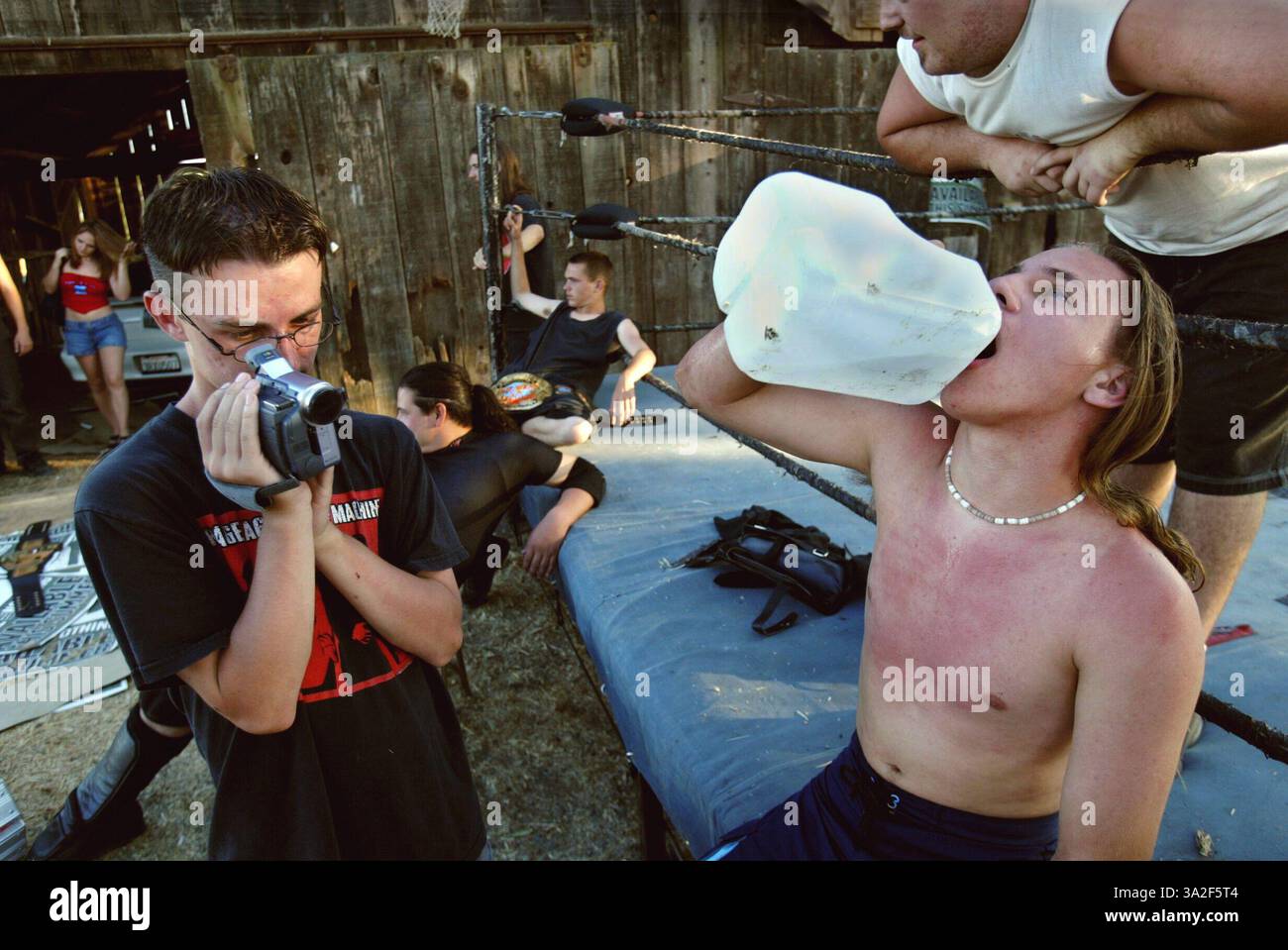 Landon Ramos takes a drink of water after his match as Matt Garrett reviews footage of the ...