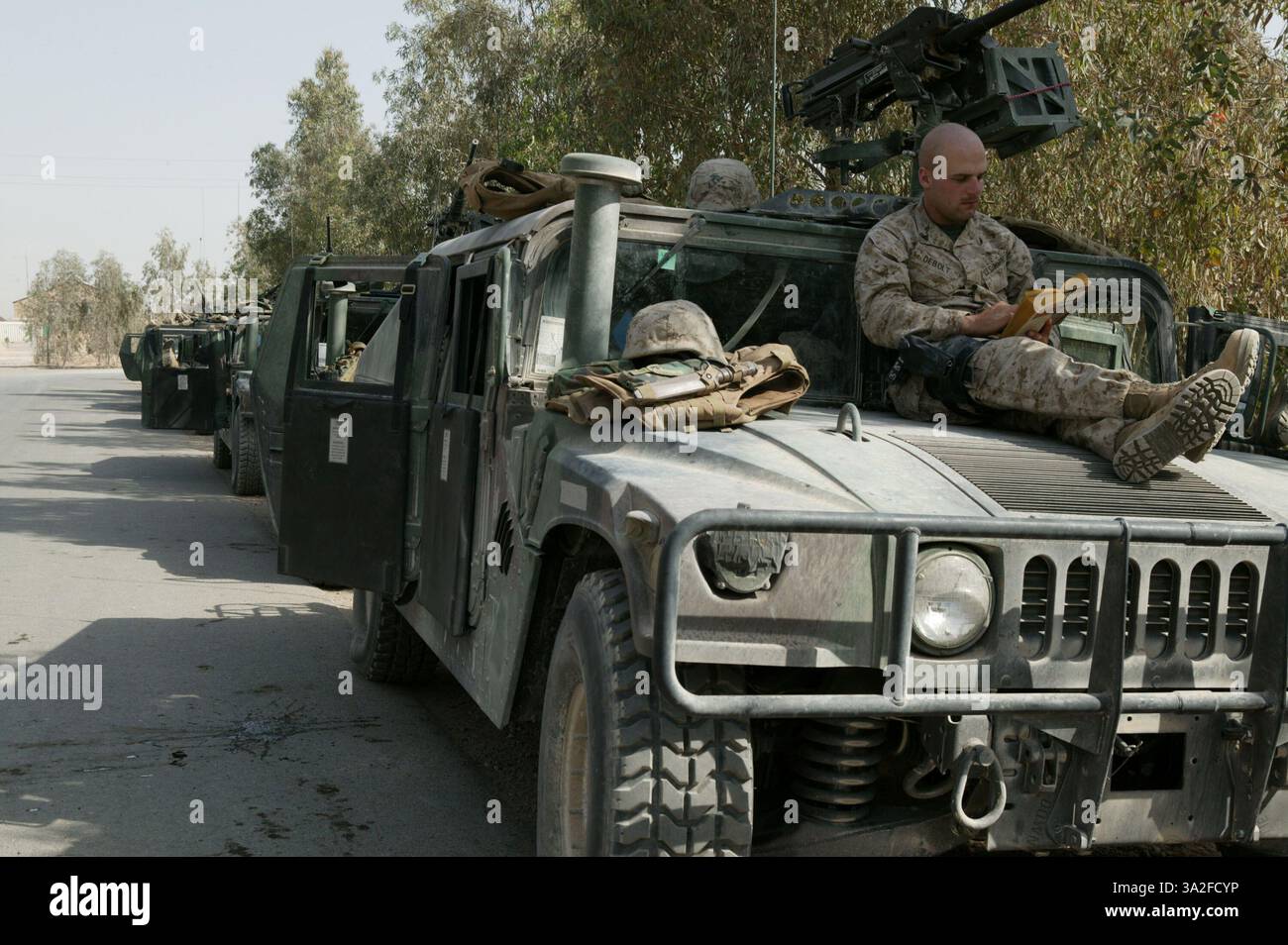 Apr 15, 2004; Fallujah, , Iraq; Cpl. MICHAEL T. DEBOLT reads a book on ...