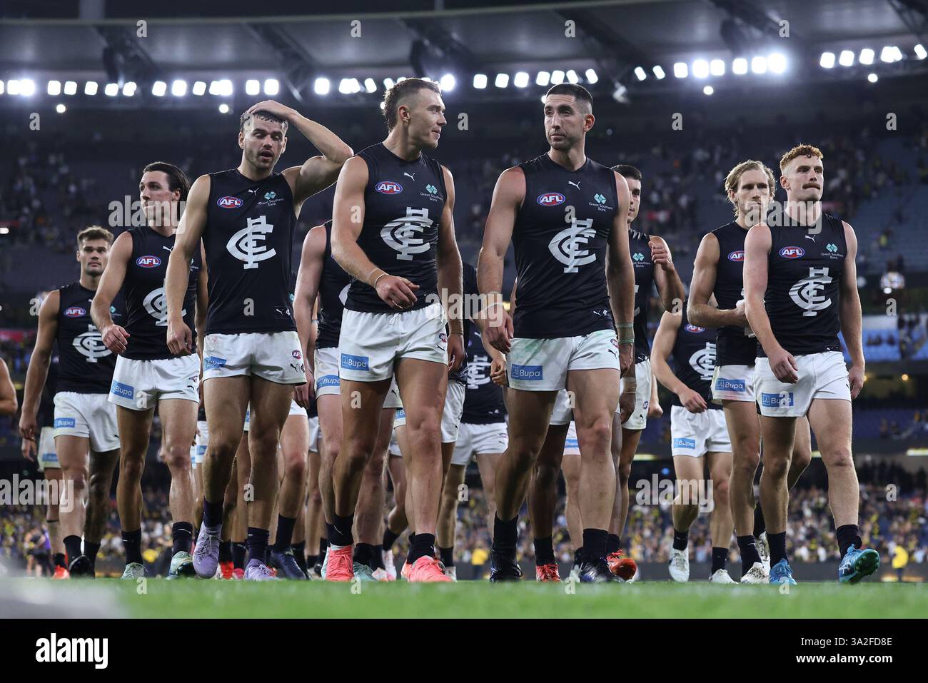 Patrick Cripps of the Blues and Jacob Weitering of the Blues lead the team off the field after ...