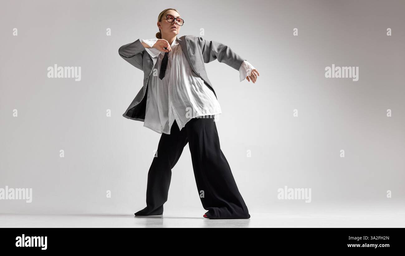 Low angle photo of young woman, dressed stylish oversized formal attire ...