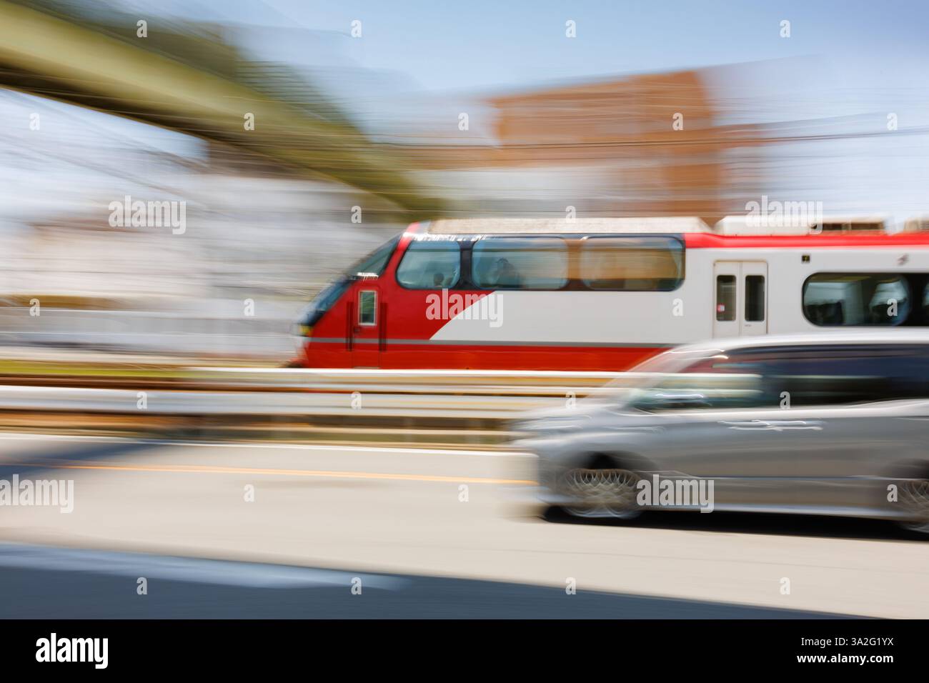 Motion blur of train and car shown side by side. Train features large ...