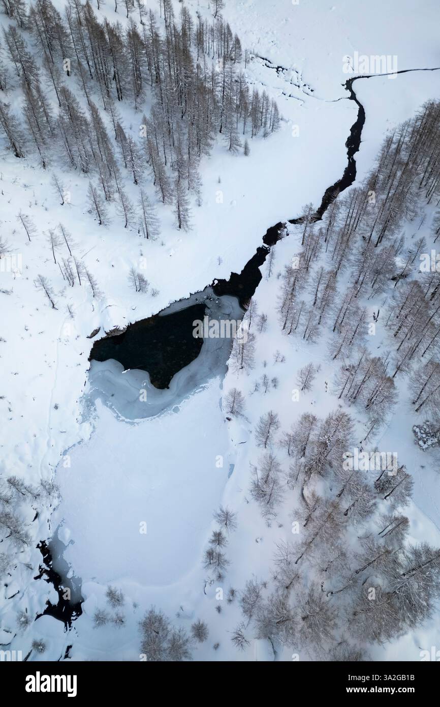 Winter view at sunrise of the Lago delle Streghe lake at Crampiolo ...
