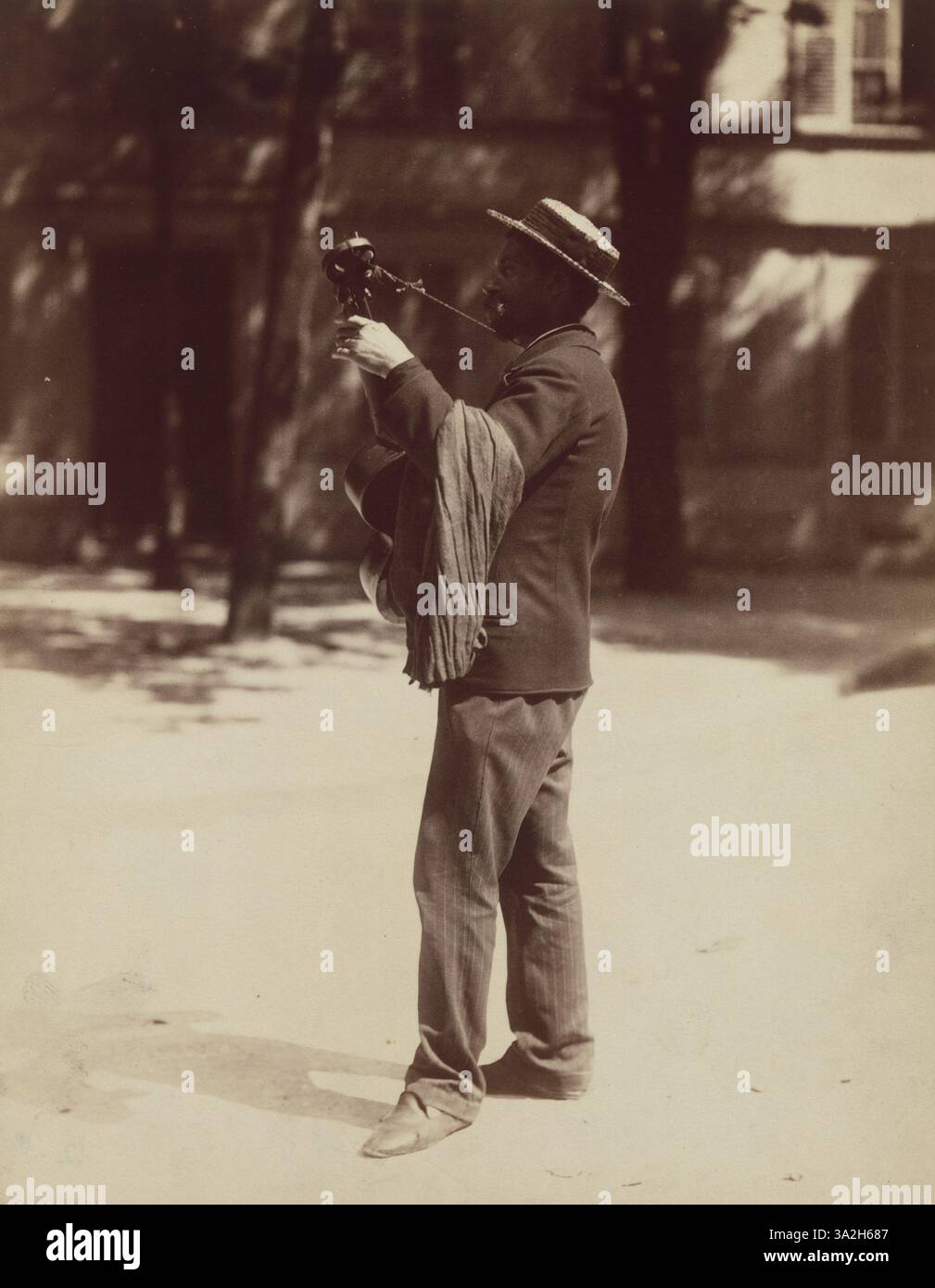 In this photograph from 1899-1900, Eugène Atget captures a guitarist ...