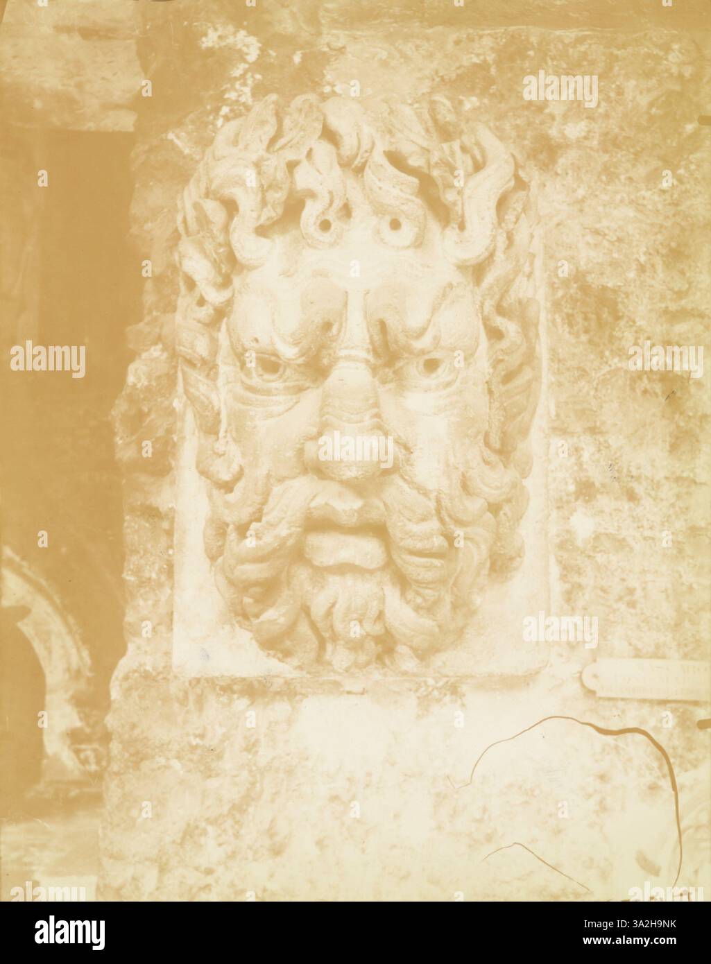 This photograph focuses on the mascarons, the sculpted faces, adorning ...